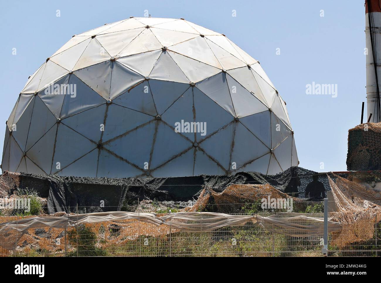 Two silhouetted Israeli soldiers, bottom right, stand next of a big ...