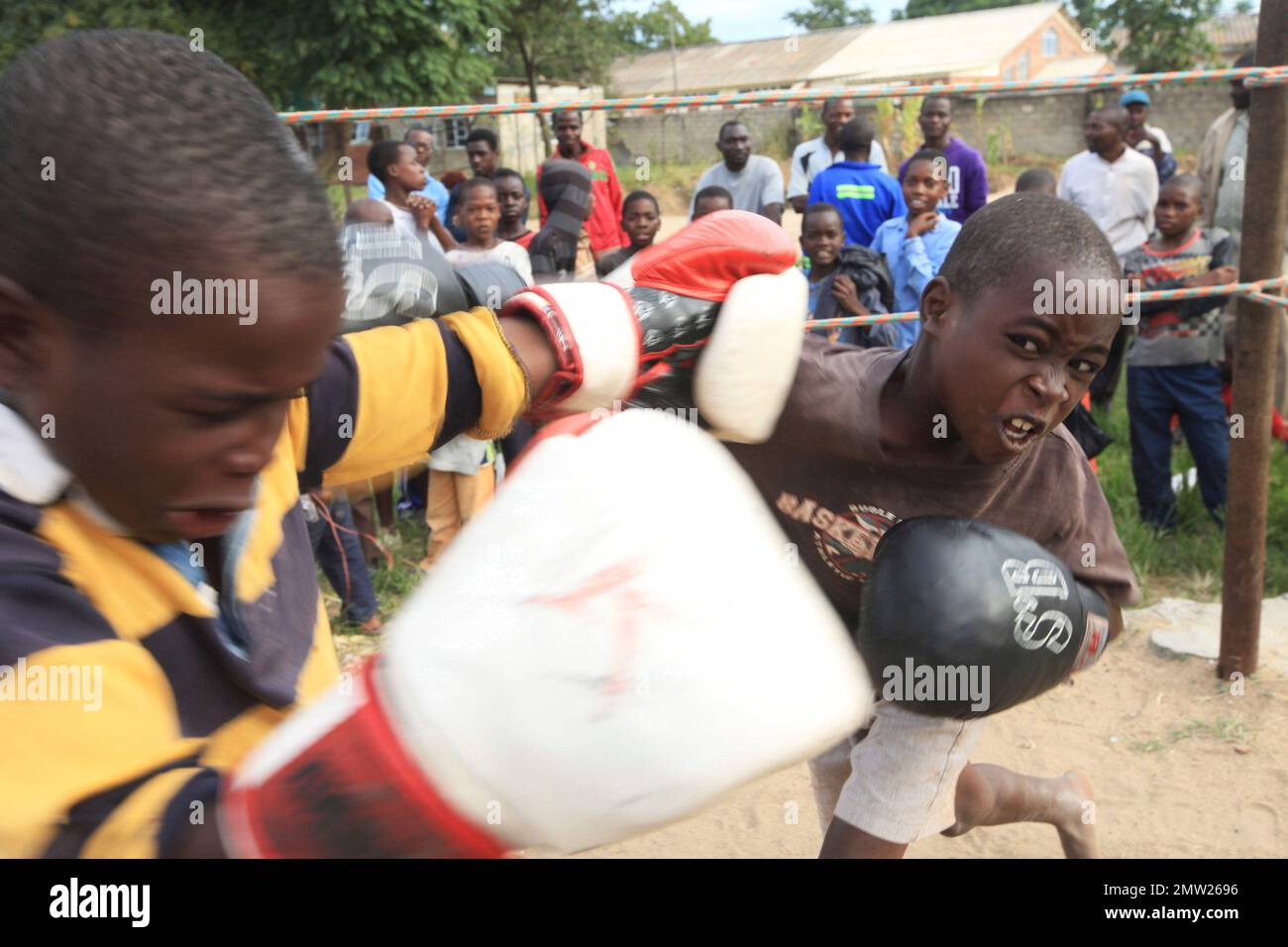 In this Sunday, March 11, 2017 photo, children fight in a boxing ring ...