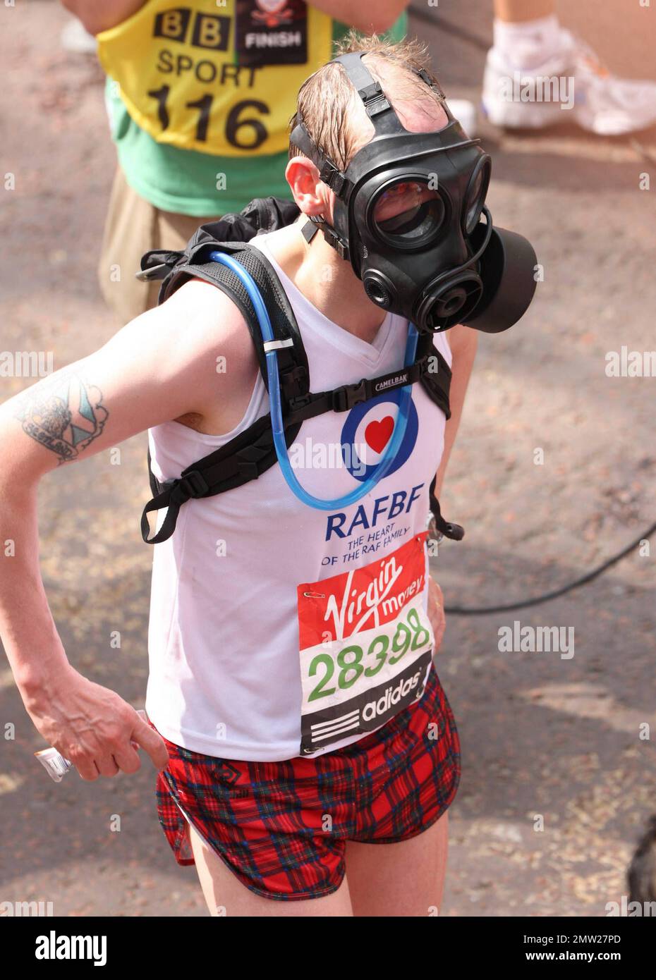 A runner wears a gas mask at the finish line following the 2011 Virgin ...