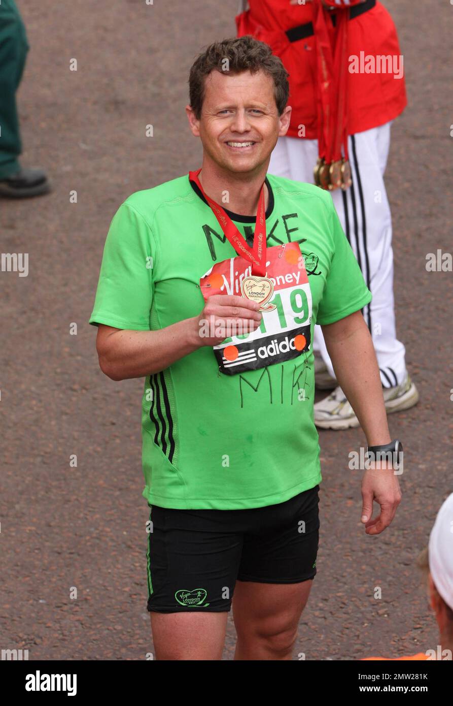 A runner at the finish line following the 2011 Virgin London Marathon ...