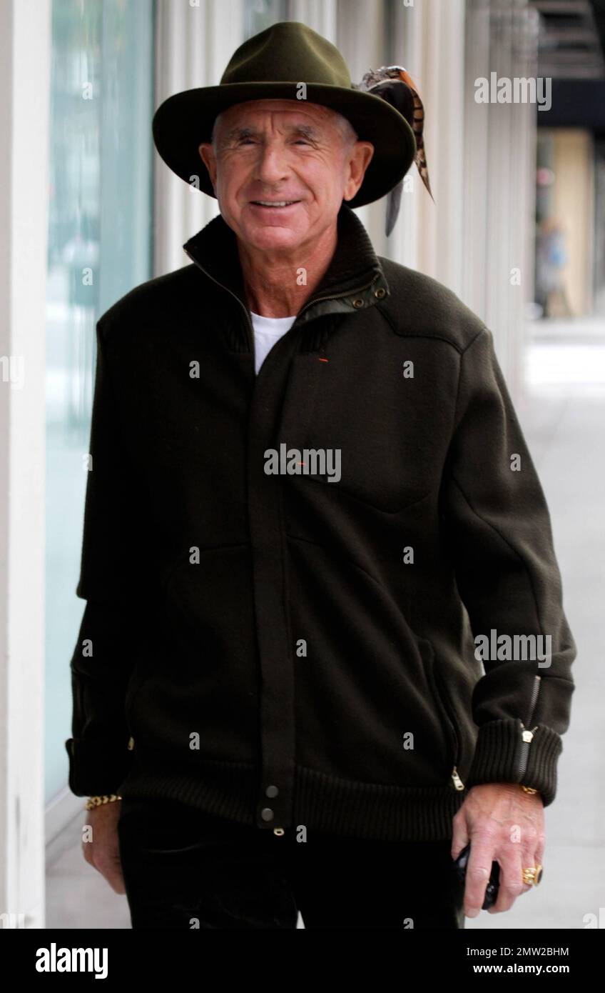 Prince Frederic Von Anhalt wears a green feathered hat and black jacket ...