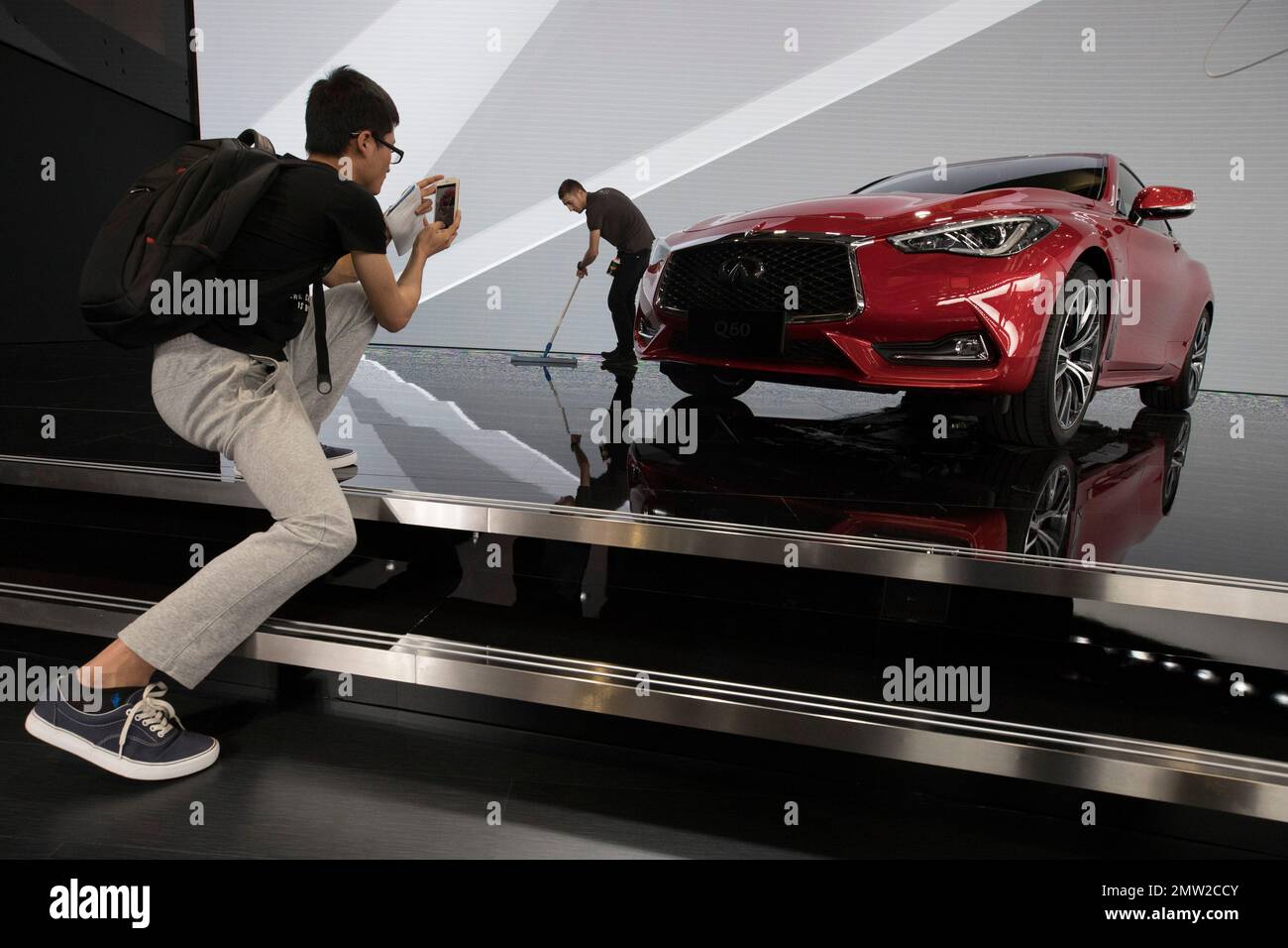 A visitor takes photo of the Lexus QX60 at the Auto Shanghai 2017 show ...