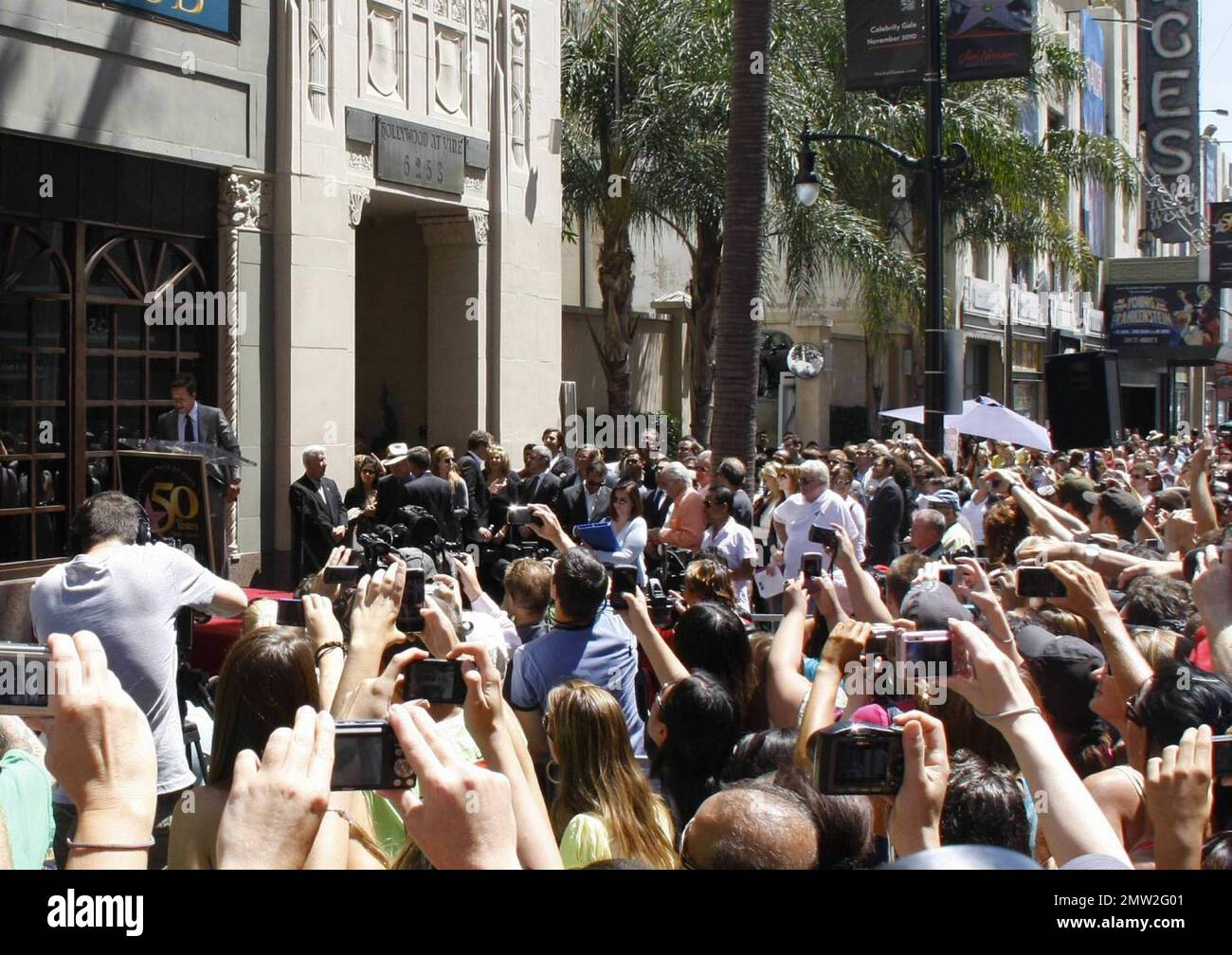 A large crowd of fans gather at Hollywood Boulevard to watch actor and ...