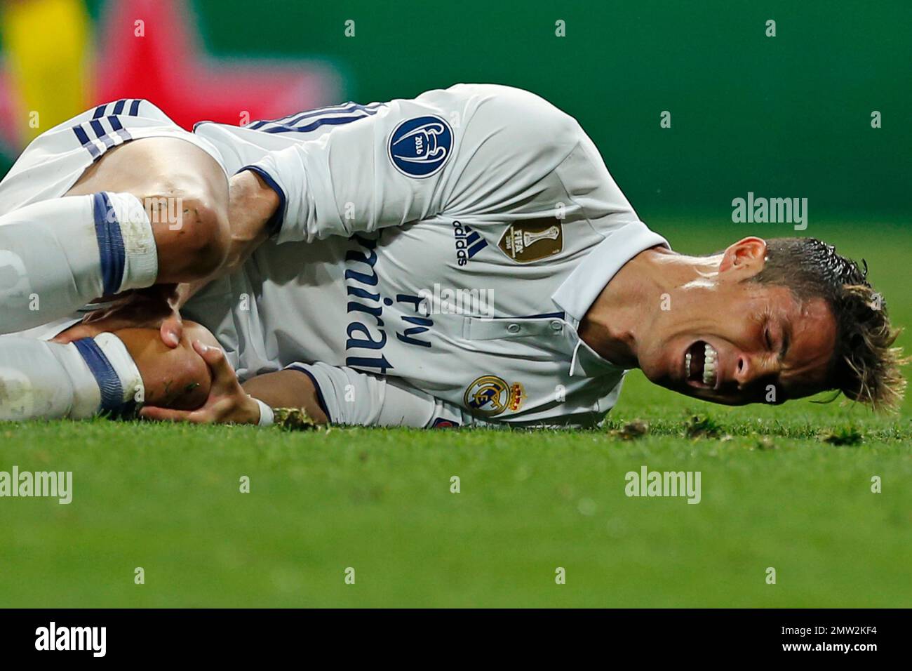 Real Madrid's Cristiano Ronaldo holds his left knee after a tackle ...