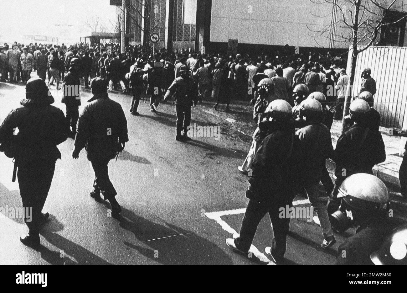 Riot police, many of them wearing gas masks, advance to disperse crowds ...
