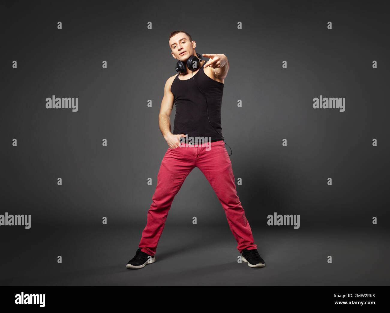 Full body portrait of young confident man posing on gray background ...
