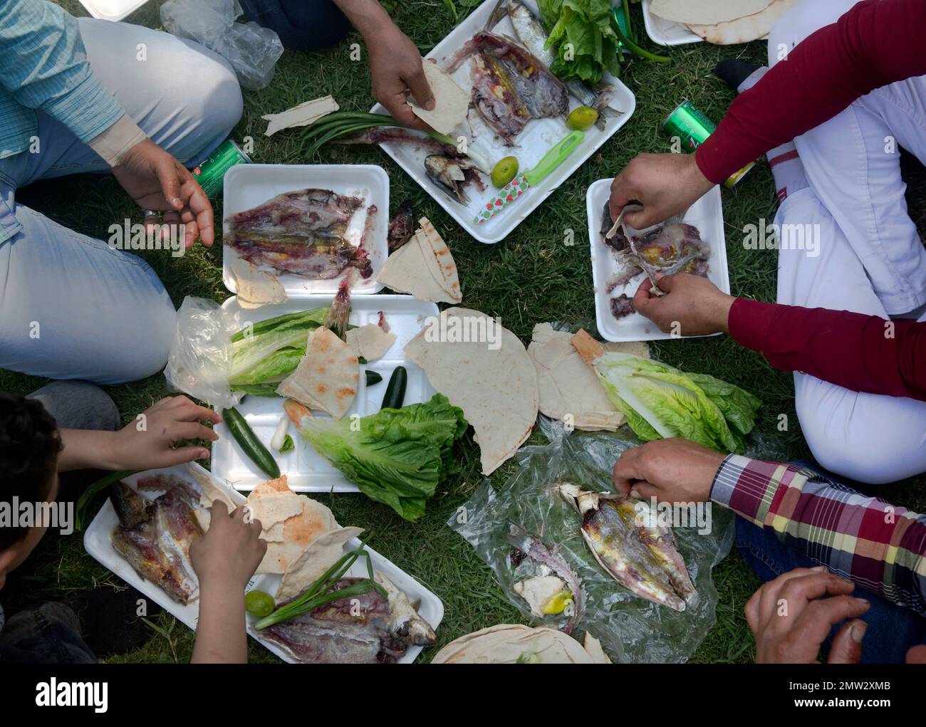 Holiday makers eat salted fish and lettuce, which is considered ...