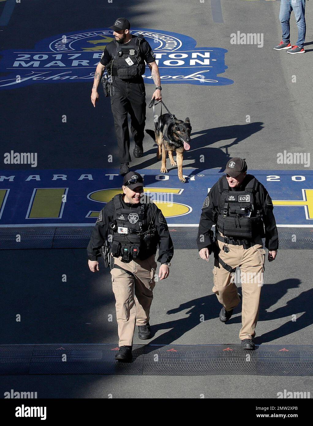 Police officers cross the finish line as they patrol before the start ...