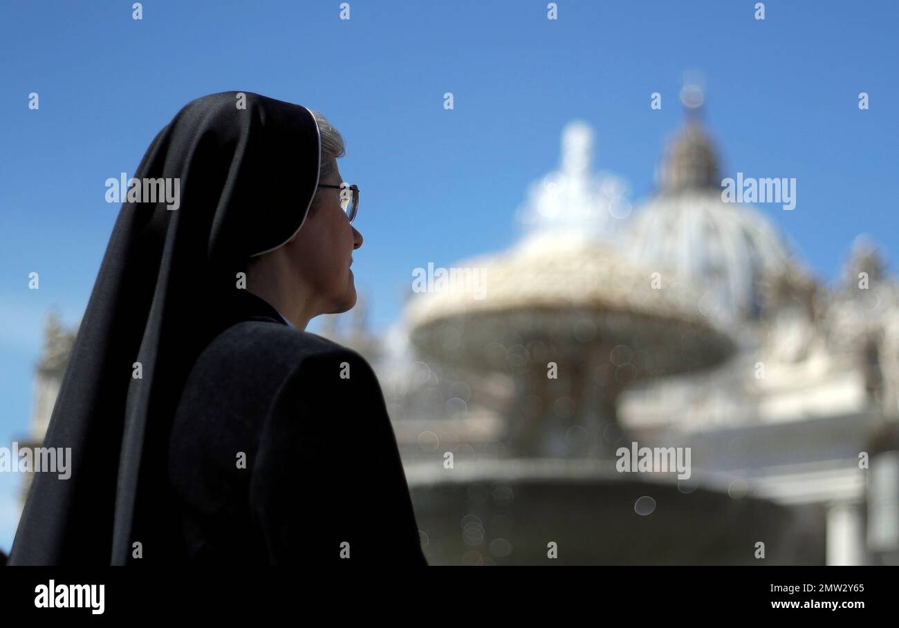 A nun looks up as she waits for Pope Francis to deliver the Regina ...
