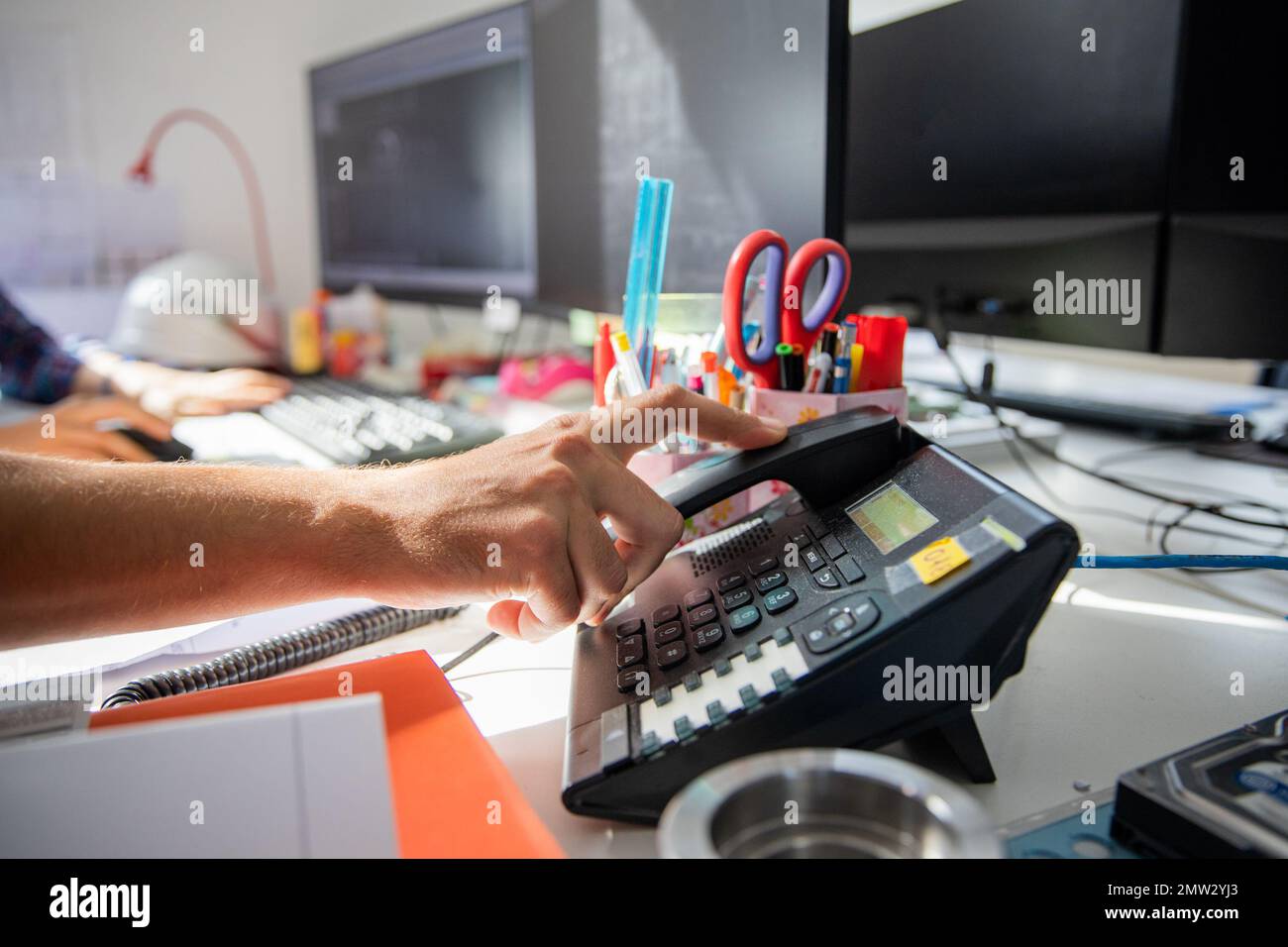 Hand of an employee who at work answers the phone in the office Stock ...
