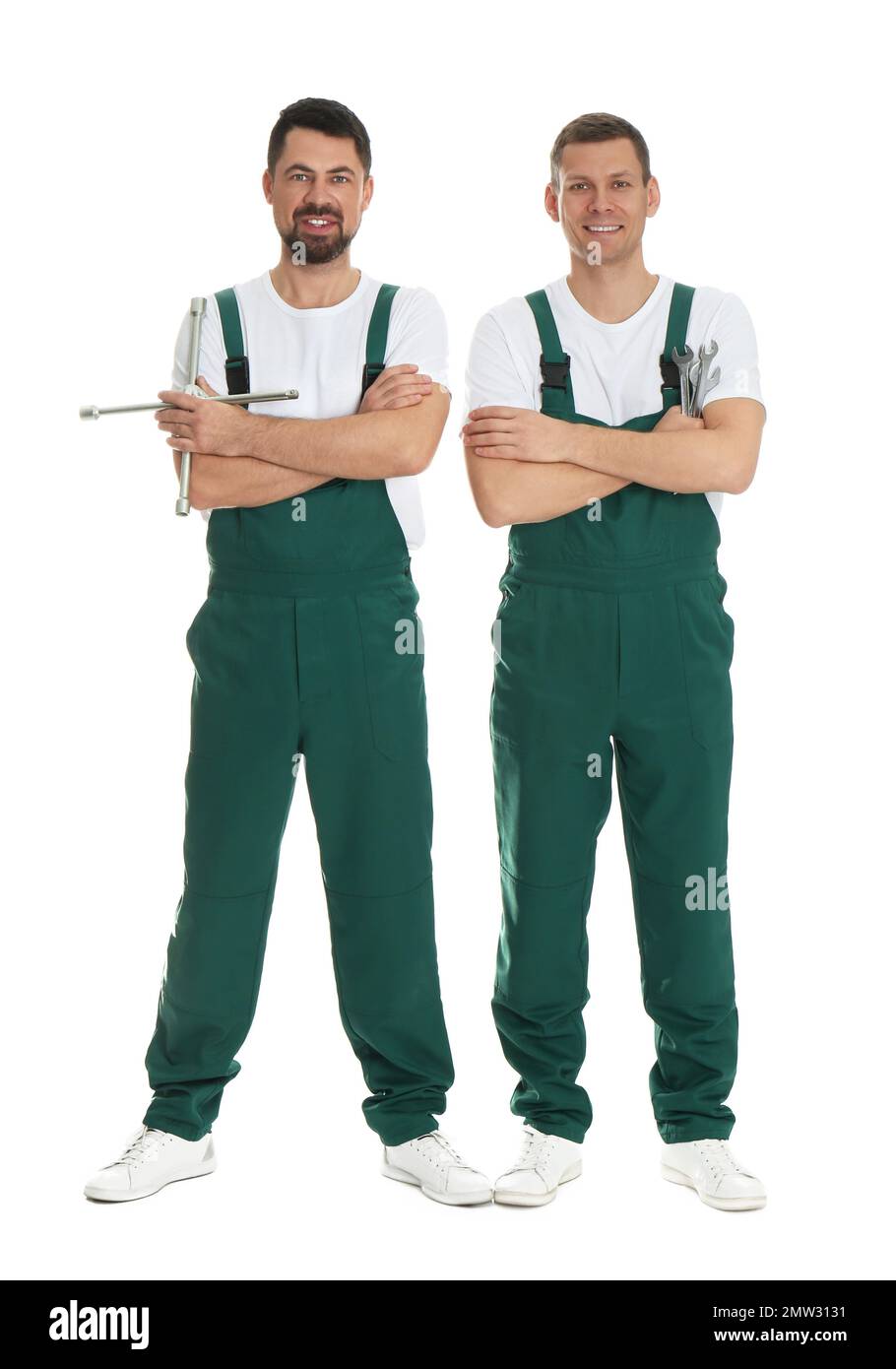 Full length portrait of professional auto mechanics on white background ...