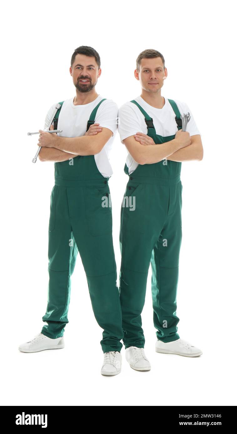 Full length portrait of professional auto mechanics on white background ...