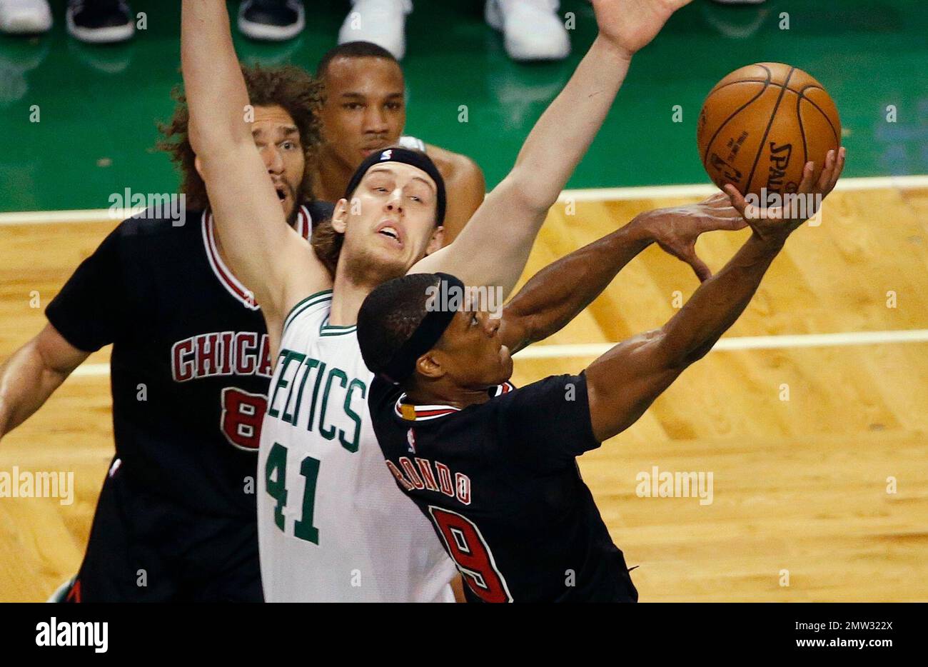 Chicago Bulls' Rajon Rondo (9) goes up to shoot in front of Boston ...