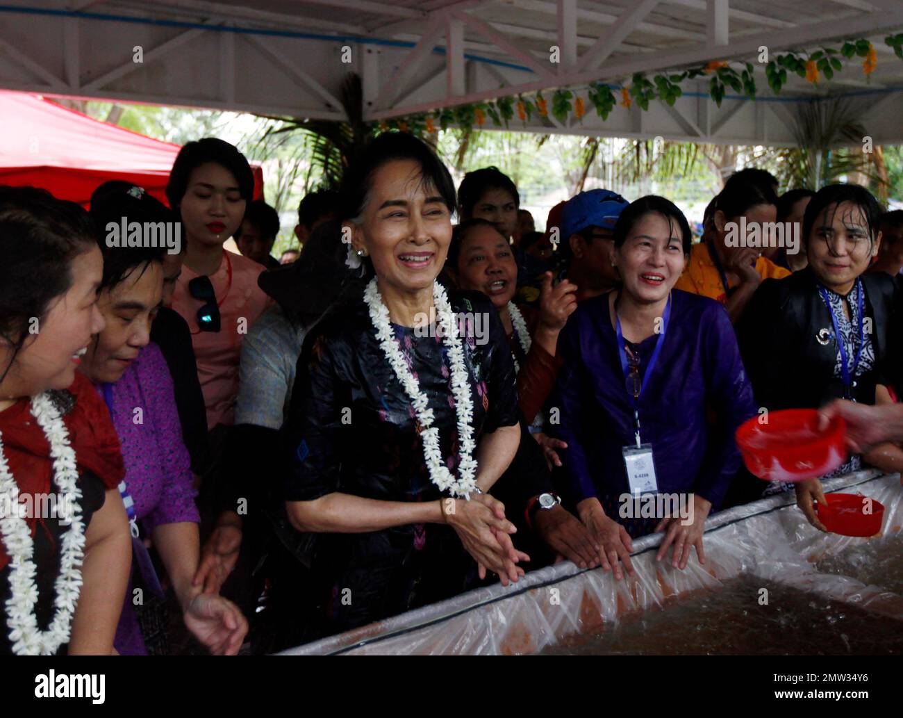 Myanmar's State Counsellor Aung San Suu Kyi, center, claps along with ...