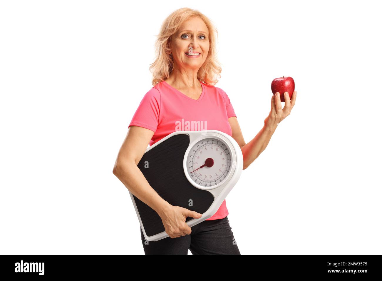 Mature woman holding a measuring scale and a red apple isolated on ...