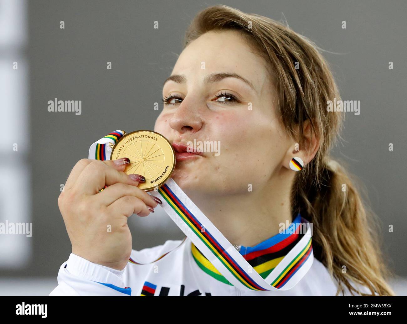 Germany's Kristina Vogel holds up her gold medal on the podium after ...