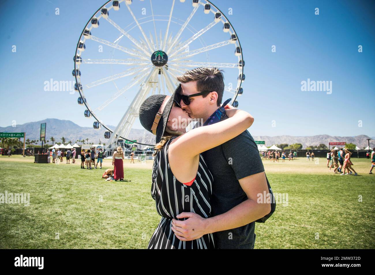 Festival goers Sarah Willetts, left, and Alex Deluccia embrace at ...