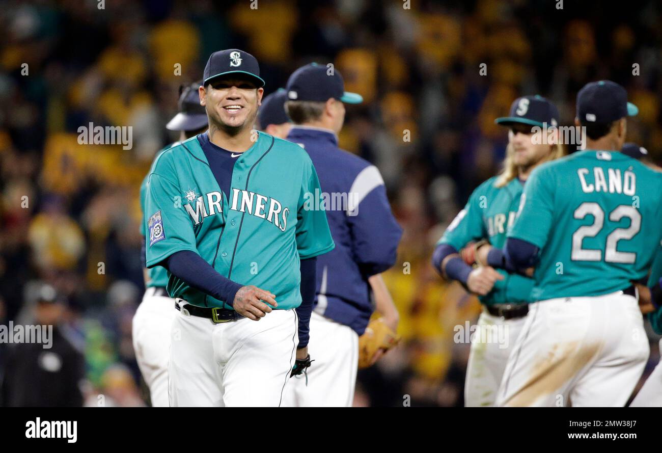 Seattle Mariners starting pitcher Felix Hernandez smiles as he heads ...