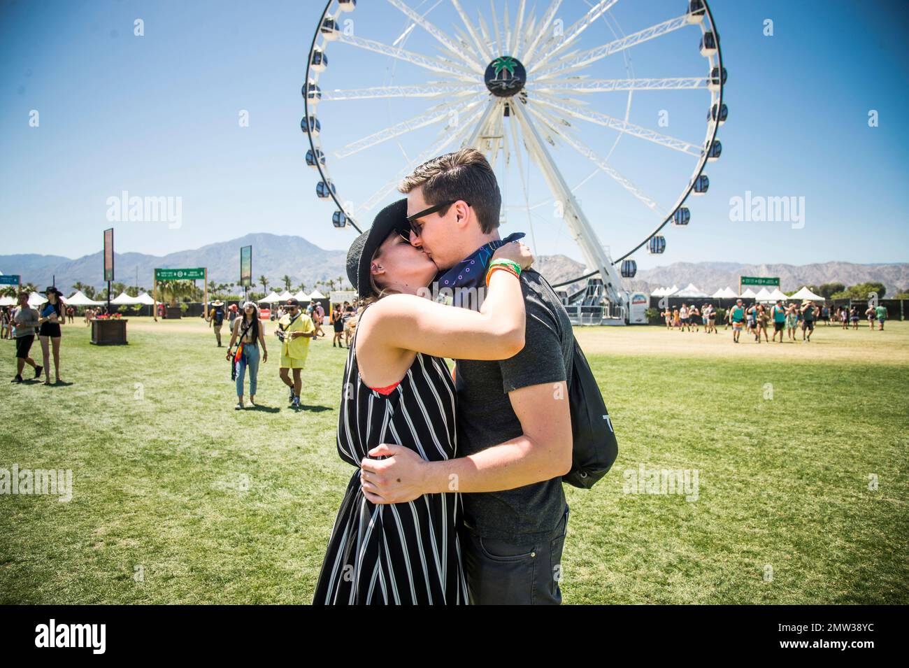 Festival goers Sarah Willetts, left, and Alex Deluccia embrace at ...