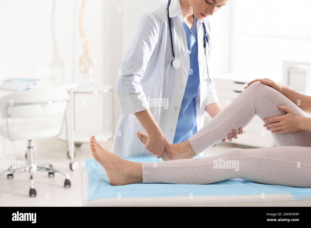 Female orthopedist examining patient's leg in clinic, closeup Stock ...