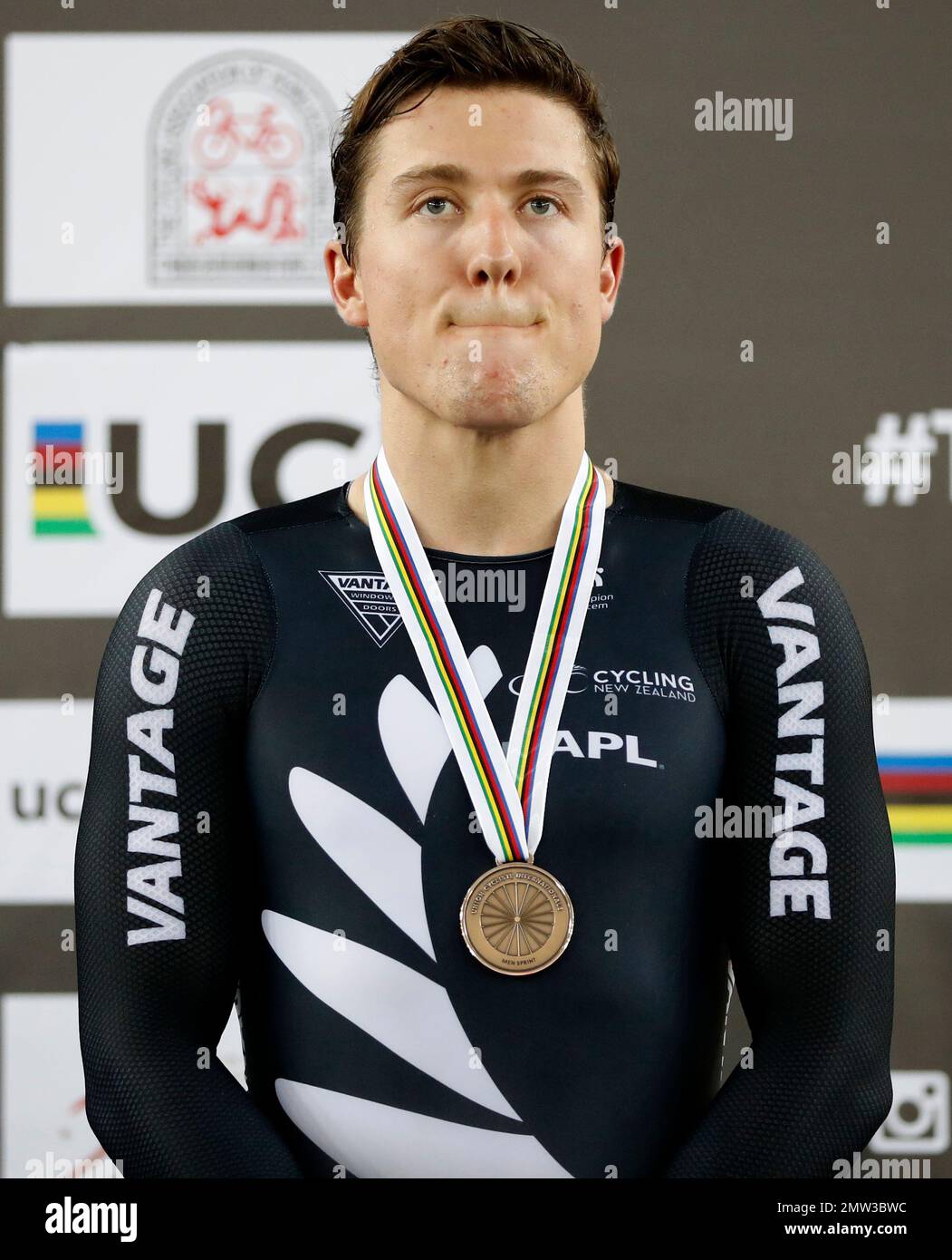 New Zealand's Ethan Mitchell stands on the podium after reaching a ...