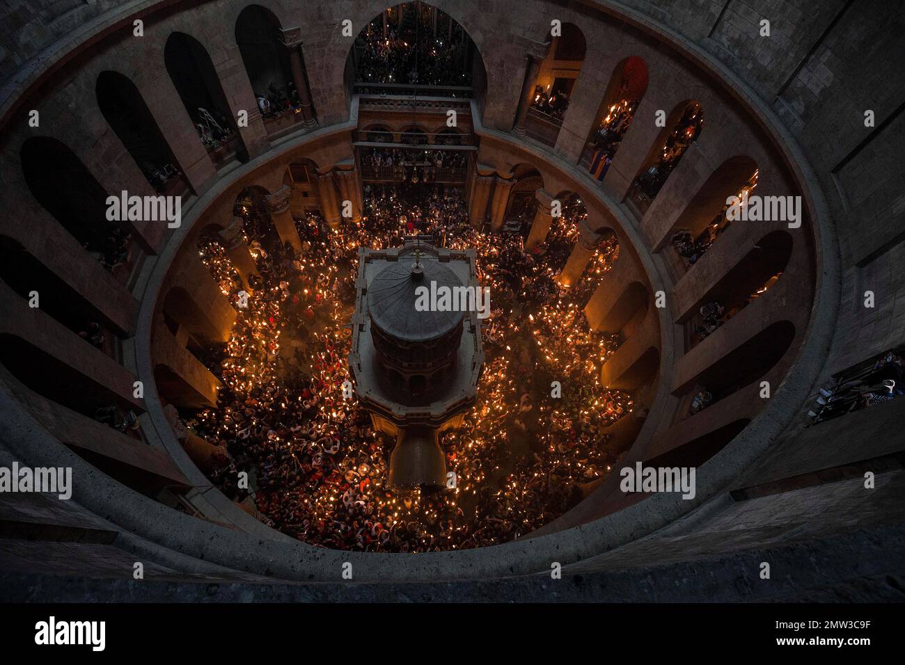 Christian pilgrims light candles during the Holy Fire ceremony in the ...