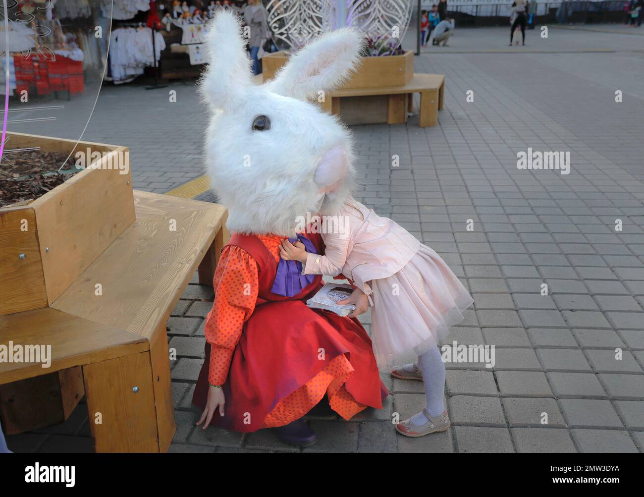 In this Thursday, April 13, 2017, picture a child hugs an entertainers ...