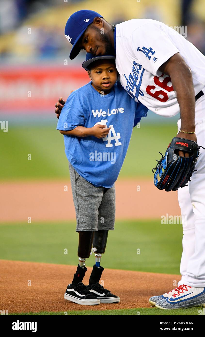 Zion Harvey, 10, gets a hug from Los Angeles Dodgers' Yasiel Puig after ...
