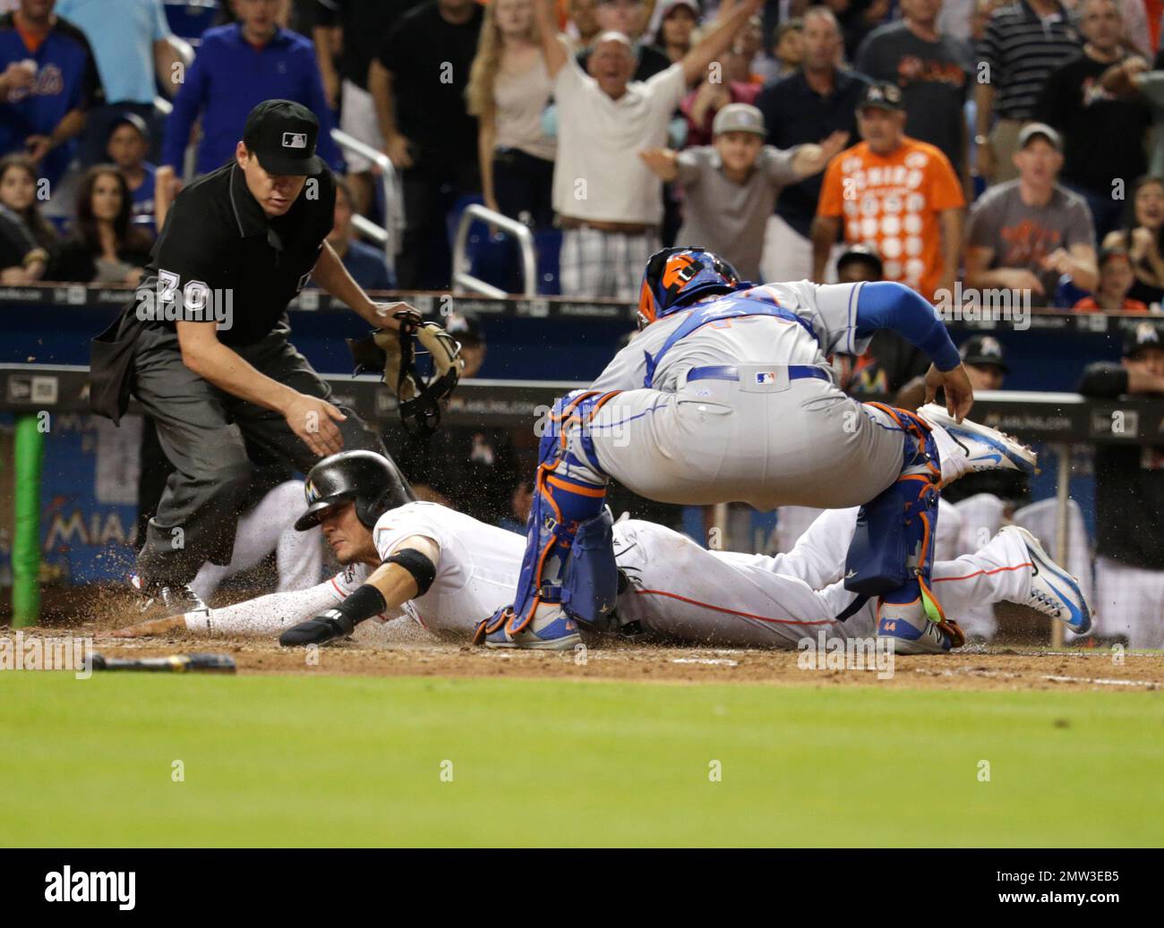 Miami Marlins' Miguel Rojas, left, is tagged out at the plate by New ...