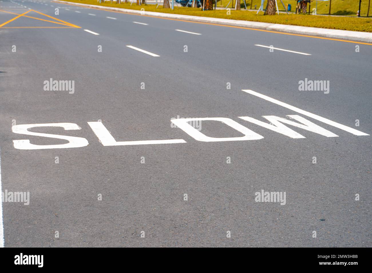 Empty road with slow down text Stock Photo - Alamy
