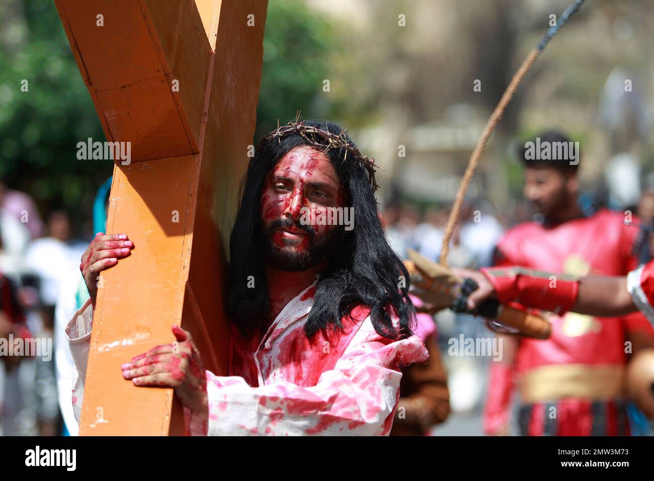 A Christian devotee reenacts the crucifixion of Jesus Christ during a ...