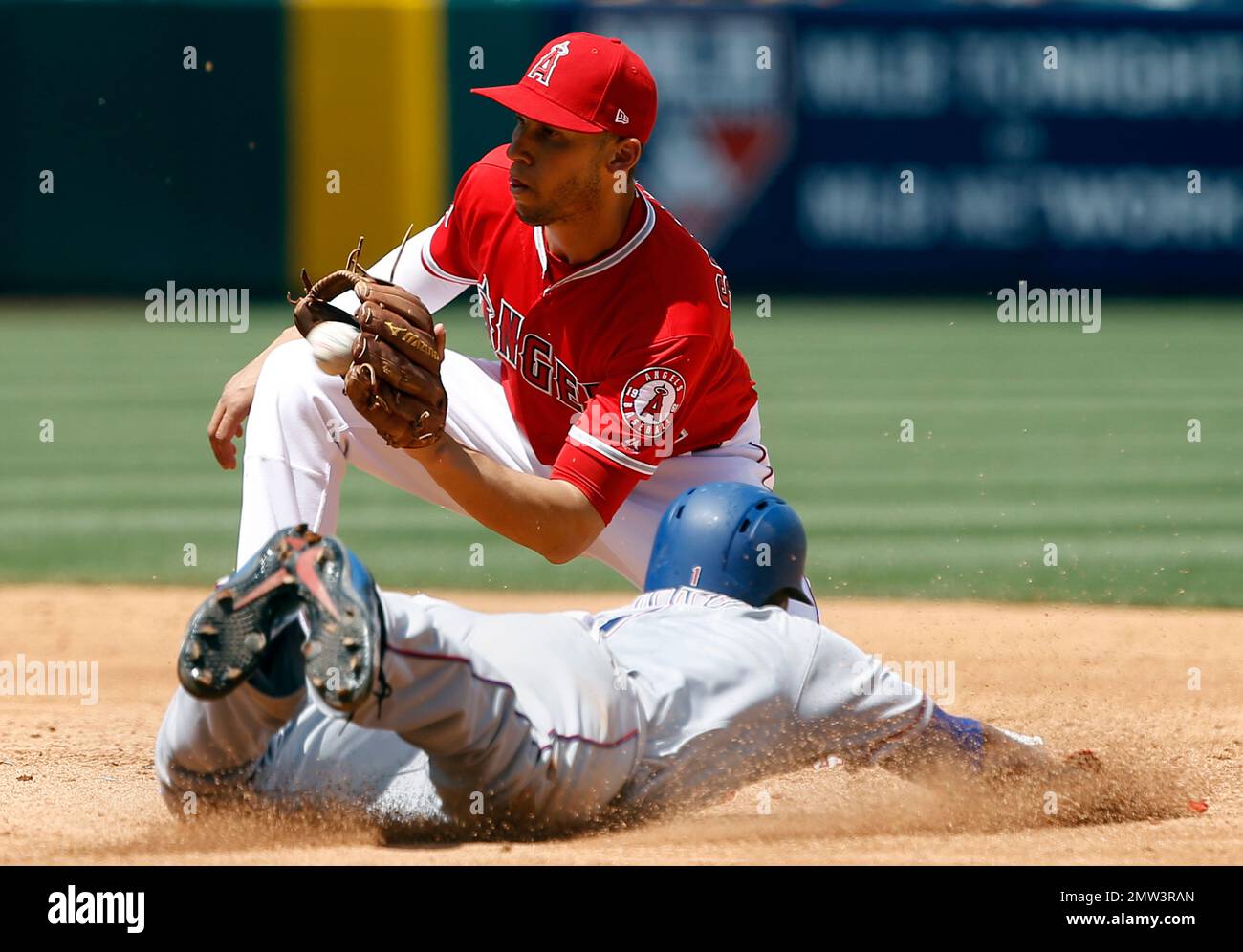 Los Angeles Angels shortstop Andrelton Simmons, above, catches the ball ...