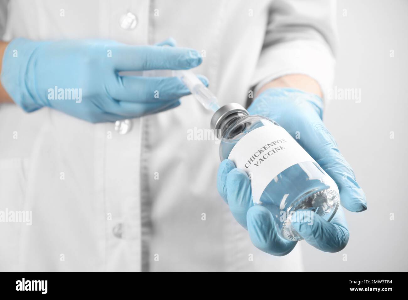 Doctor filling syringe with chickenpox vaccine, closeup. Varicella ...