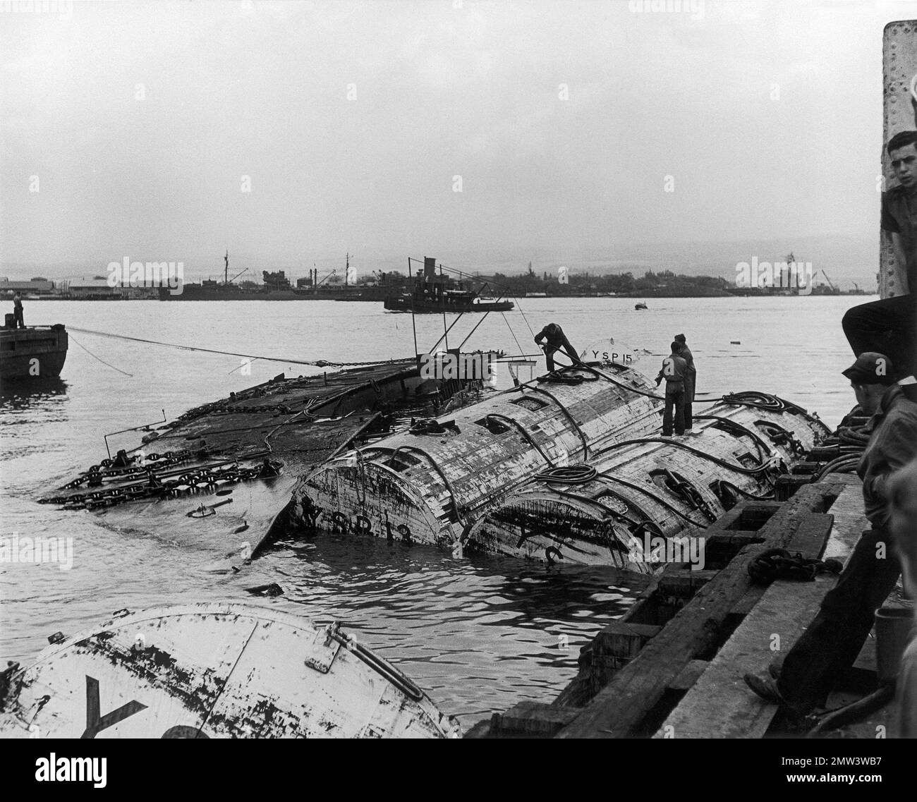 In this photo provided by the U.S. Navy, the side of the hull of the ...