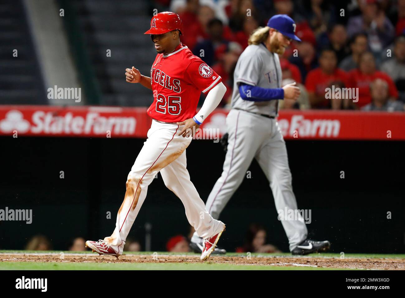 Los Angeles Angels' Ben Revere, left, scores on a sacrifice fly by ...