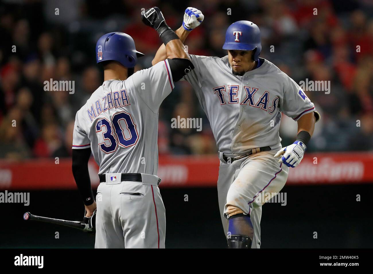 Texas Rangers' Carlos Gomez, right, celebrates with Nomar Mazara, left ...