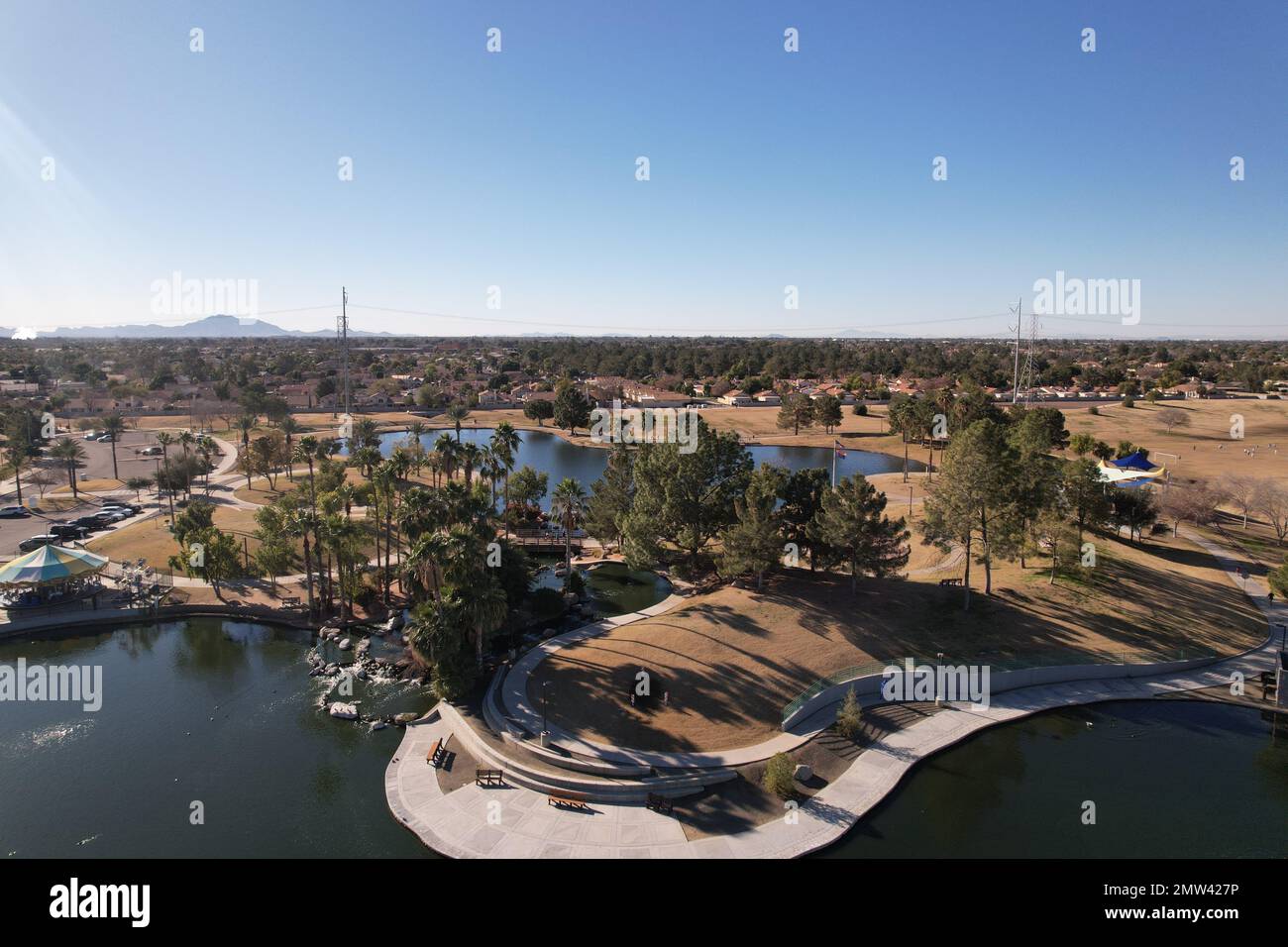 An aerial view of palm trees and lakes with green water in a park in ...