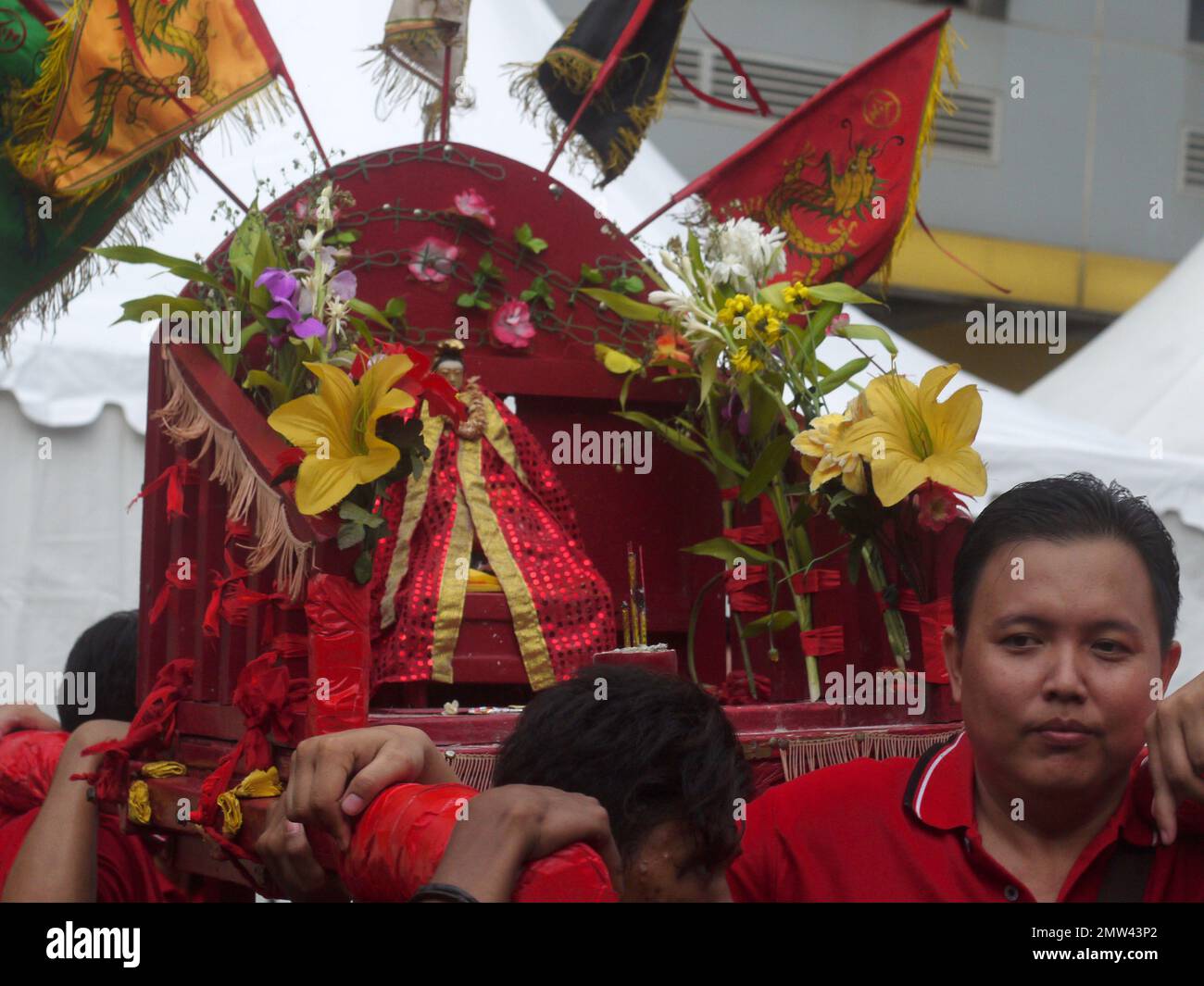 a parade carrying statues of Chinese gods during the Cap Go Meh ...