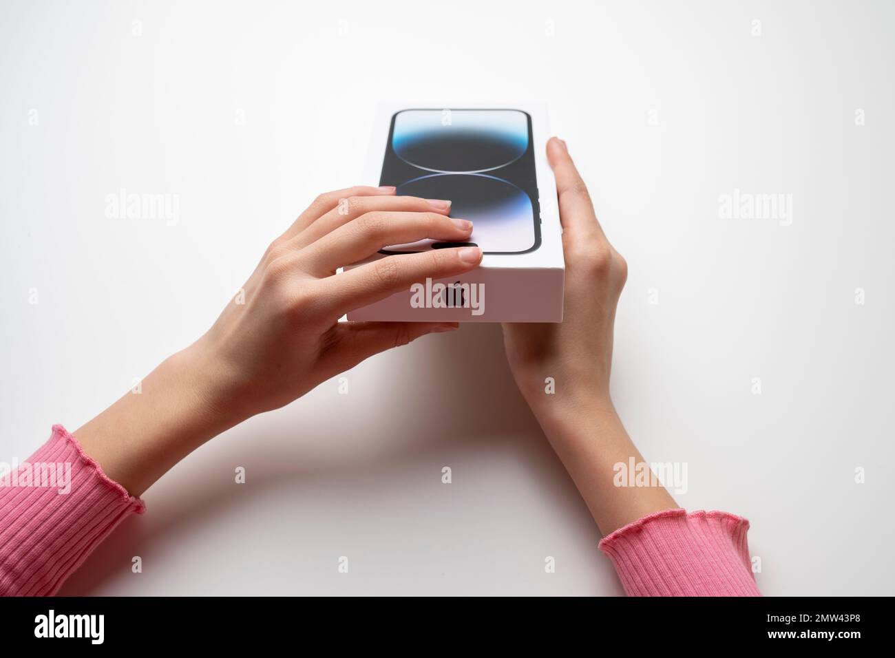 A girl holds the latest iPhone 14 Pro Max, Space Black. Apple's latest ...