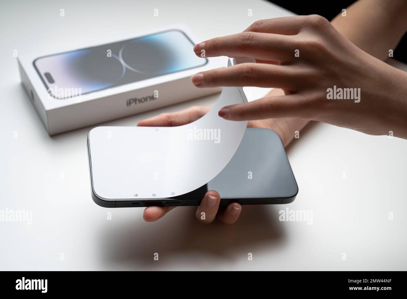 A girl holds the latest iPhone 14 Pro Max, Space Black. Apple's latest ...