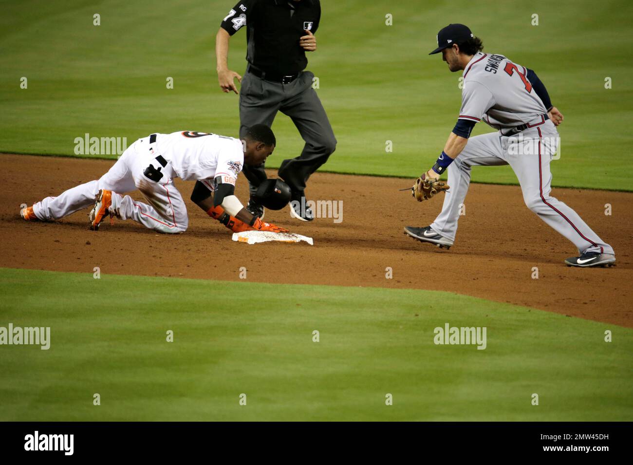 Miami Marlins' Dee Gordon, left, is safe at second with a double as he ...