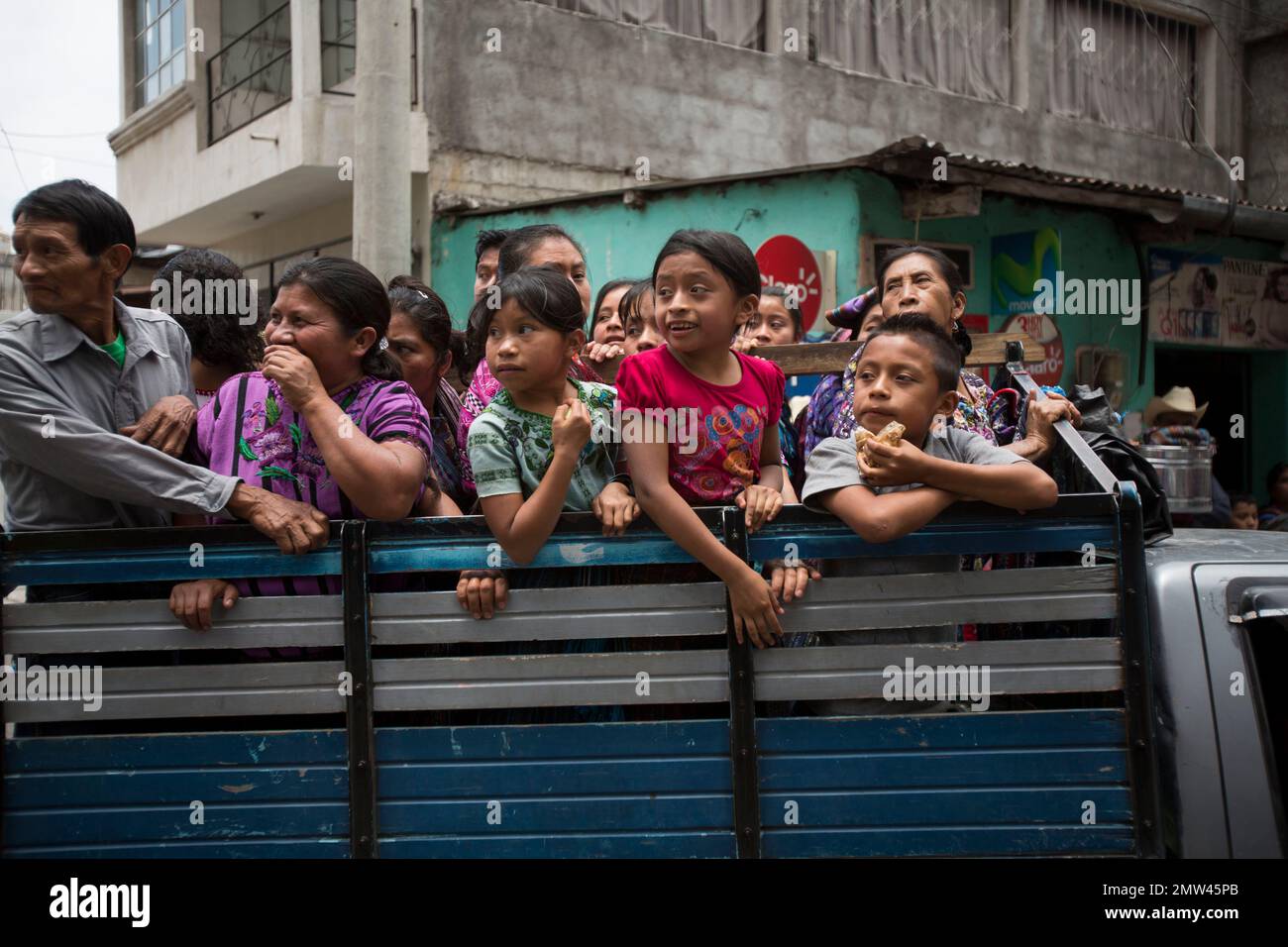 People watch from a pick up truck the procession of folk saint Maximon ...