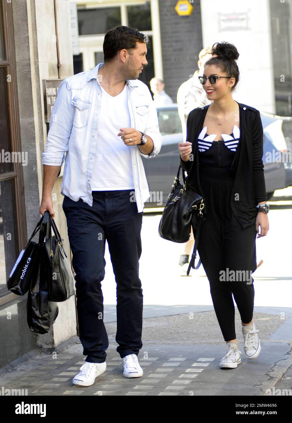 Wearing a black top with large Adidas logos strategically covering her ...