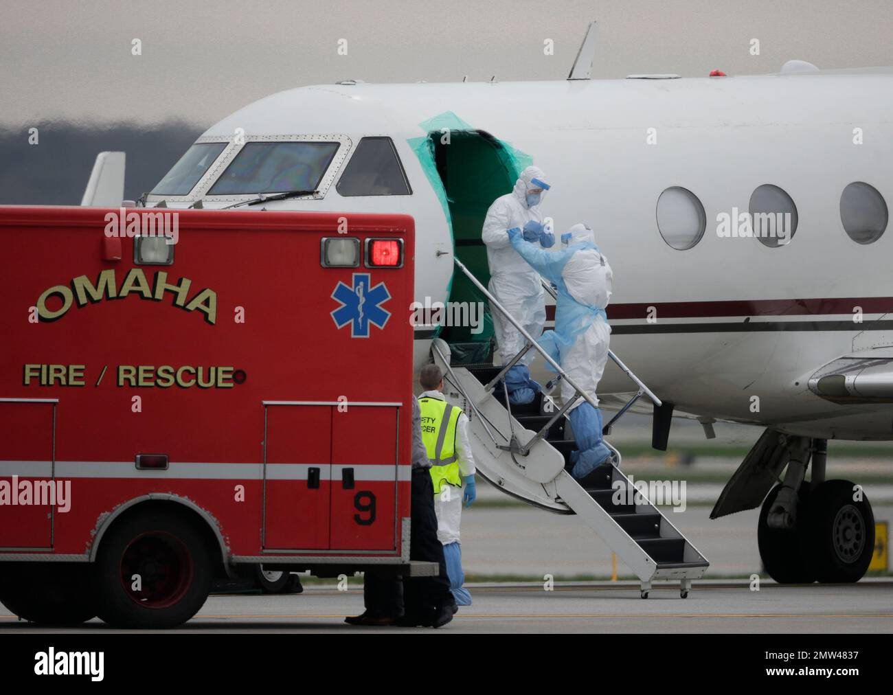 A mock-patient, top, is helped down the stairs of a Phoenix Air ...