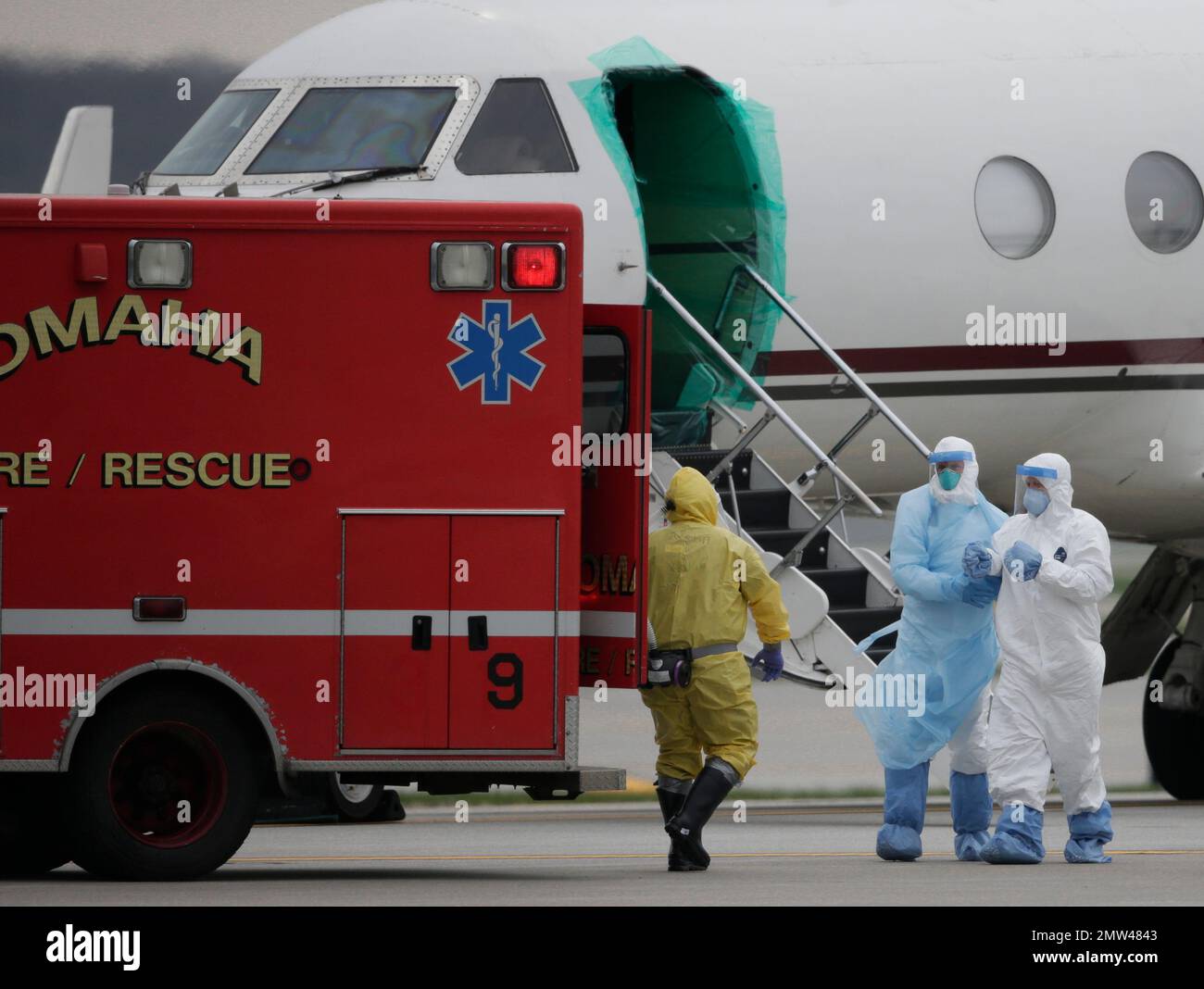A mock-patient, right, is helped to an ambulance from a Phoenix Air ...