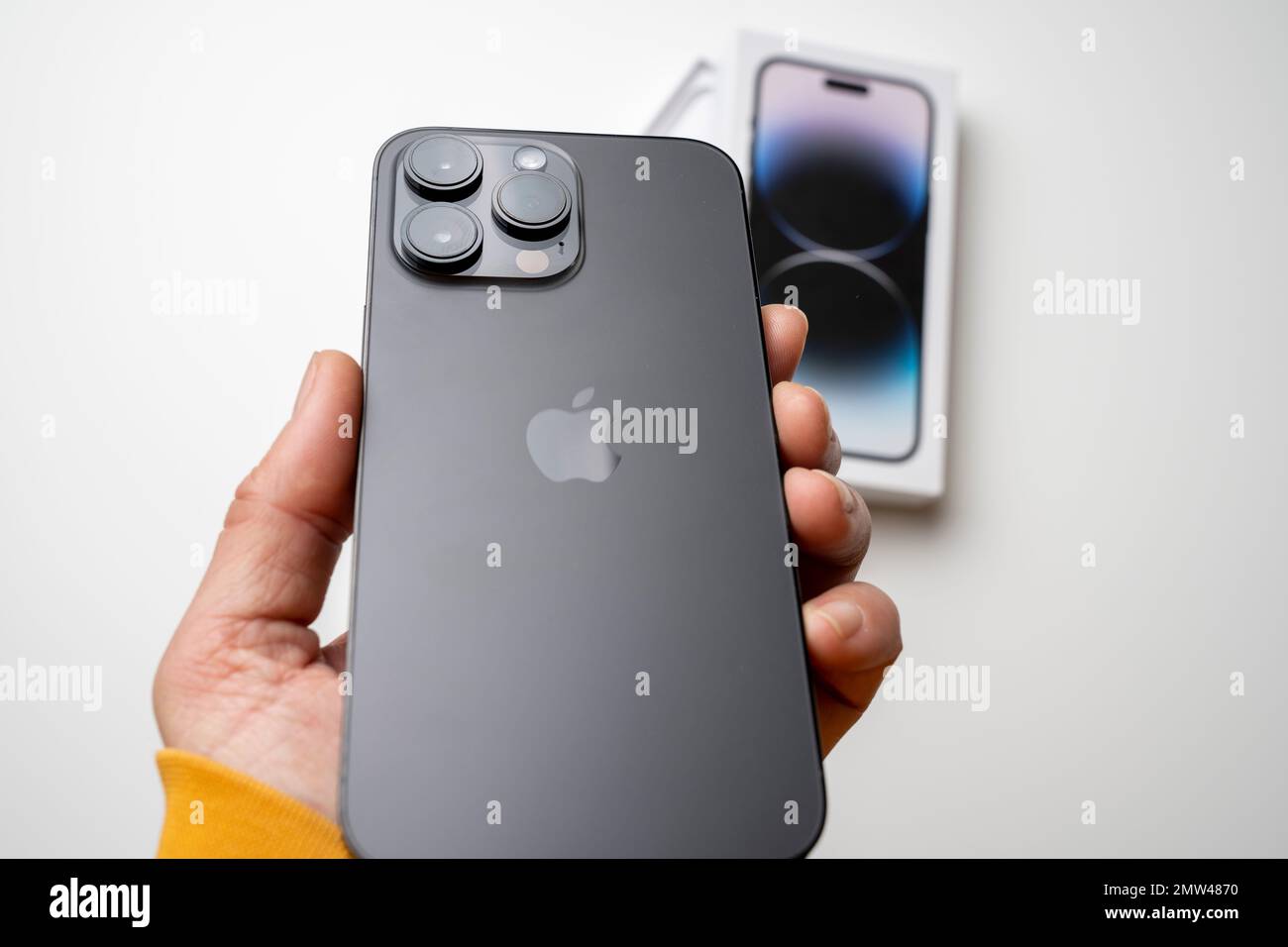 A man holds the latest iPhone 14 Pro Max in Space Black. Apple's latest ...