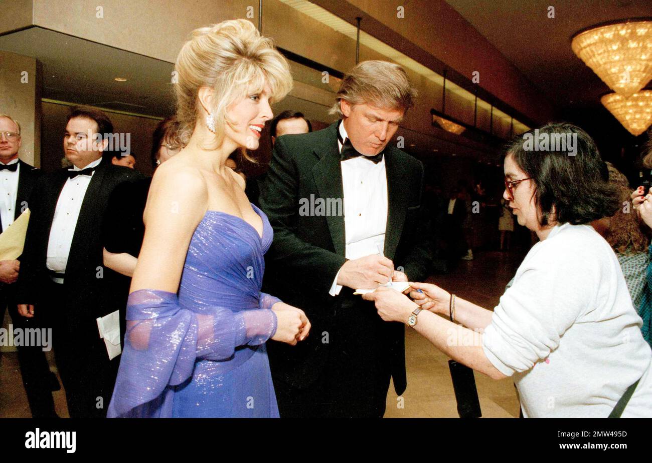 Real estate magnate Donald Trump signs an autograph for an unidentified ...