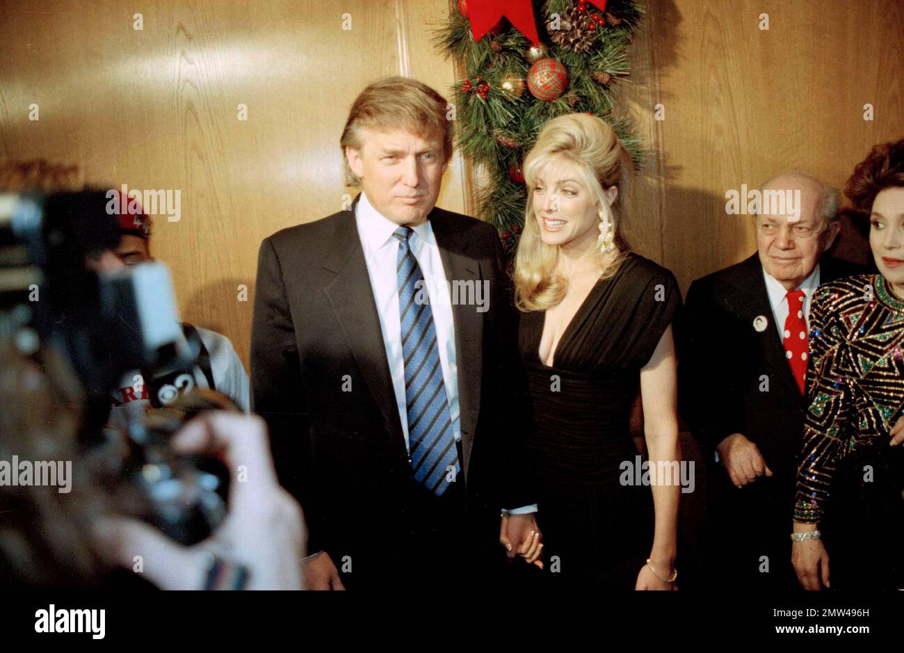 Real estate magnate Donald Trump and Marla Maples hold hands as they ...