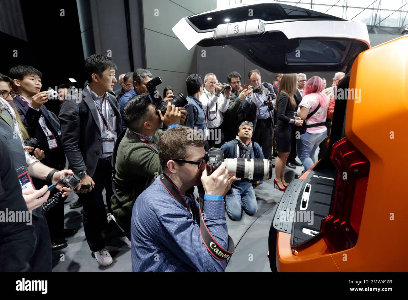 Automotive journalists crowd around the back of the the Toyota FT4X ...