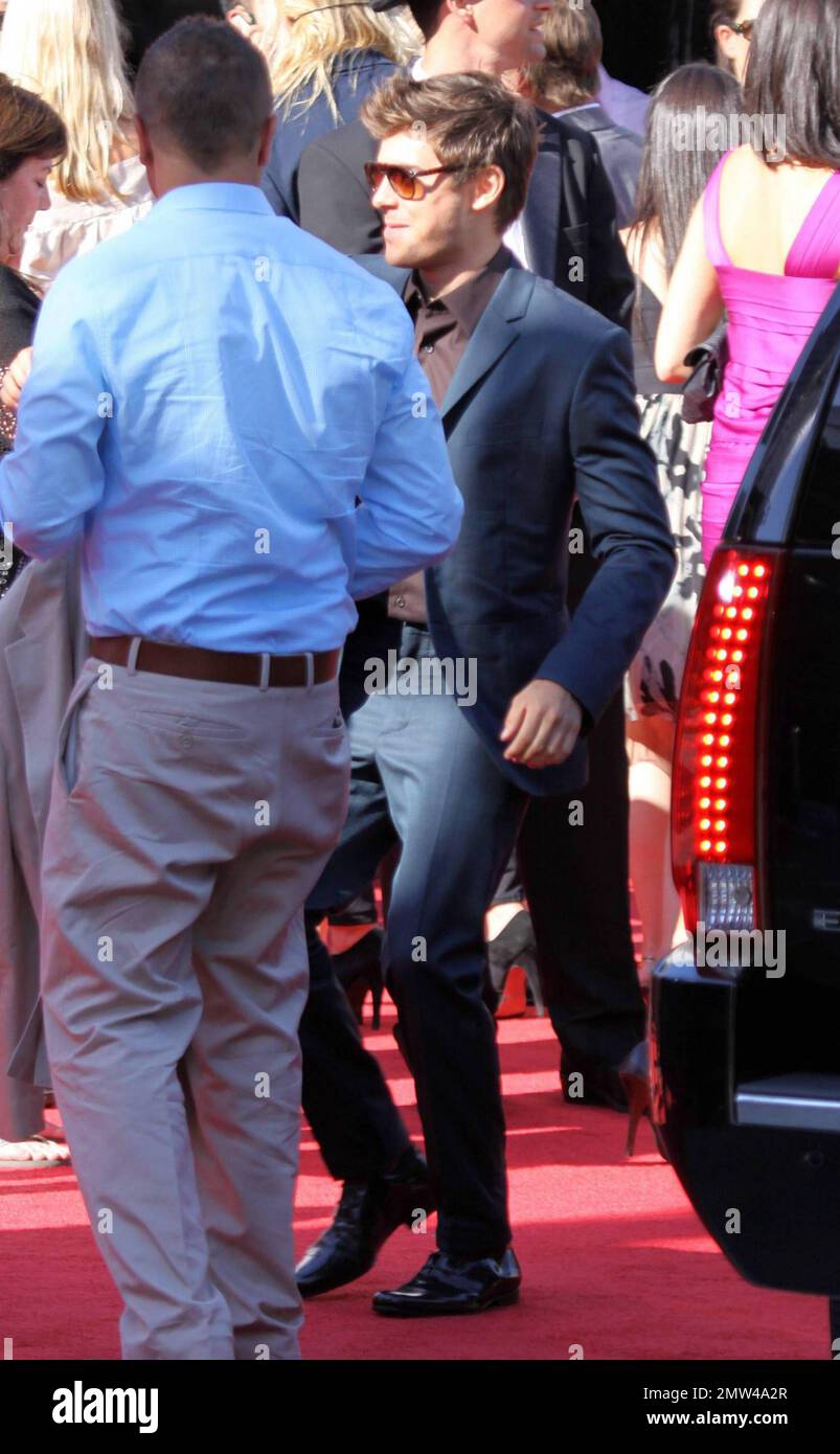 Actor Zac Efron hugs a female friend before he heads down the red ...